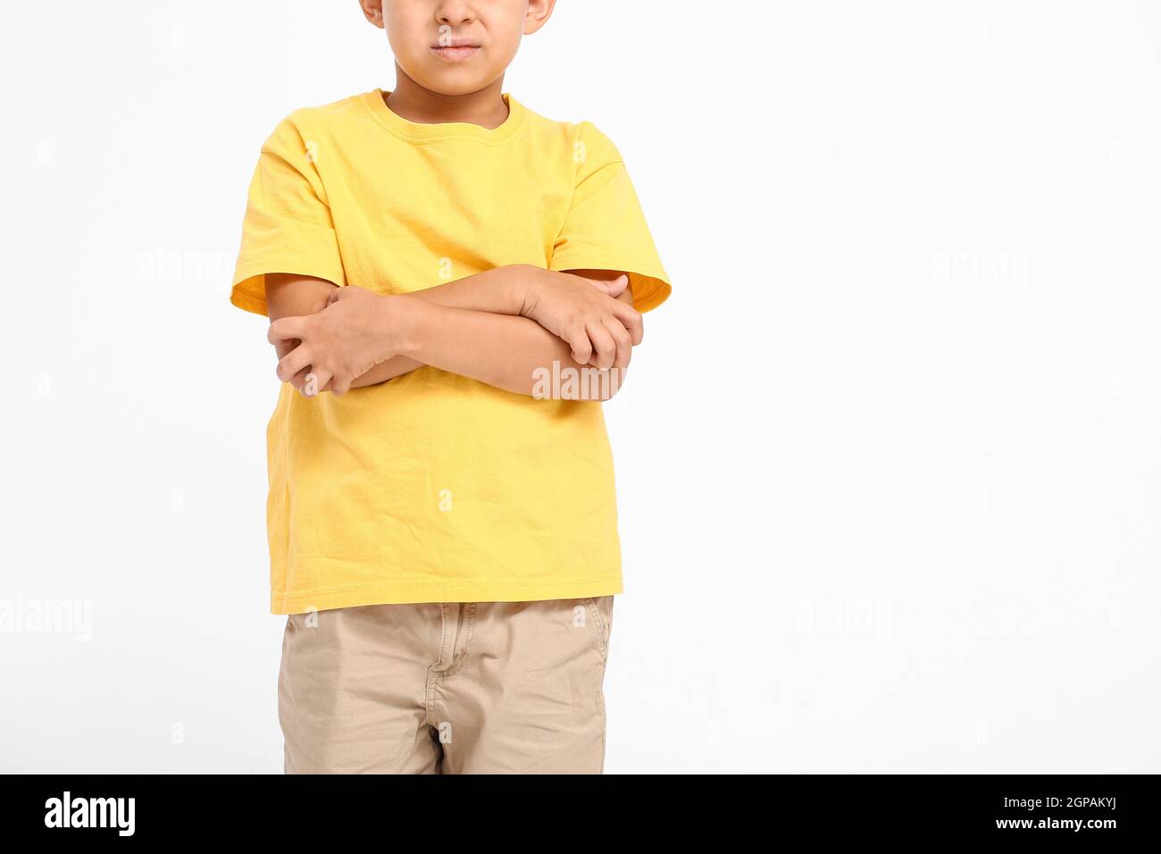 Little boy scratching himself on white background Stock Photo - Alamy