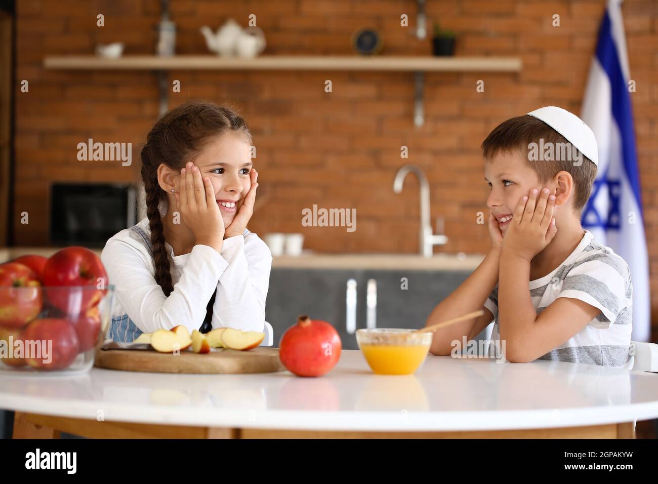 Little children celebrating Rosh Hashanah (Jewish New Year) at home ...