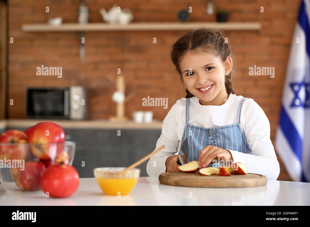 Little girl celebrating Rosh Hashanah (Jewish New Year) at home Stock ...