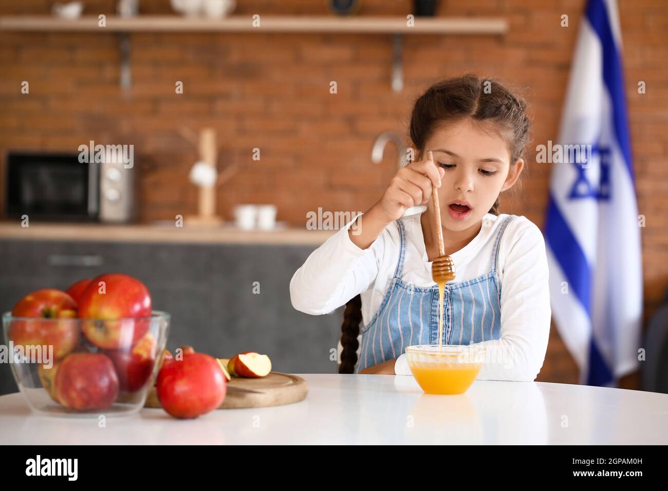 Little girl celebrating Rosh Hashanah (Jewish New Year) at home Stock ...