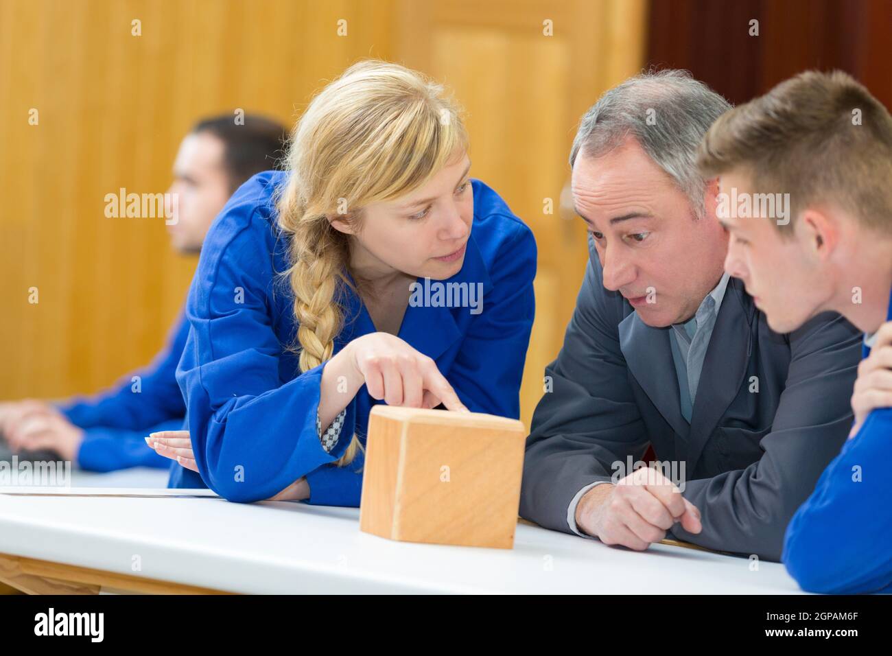 female student asking question in woodwork class Stock Photo - Alamy