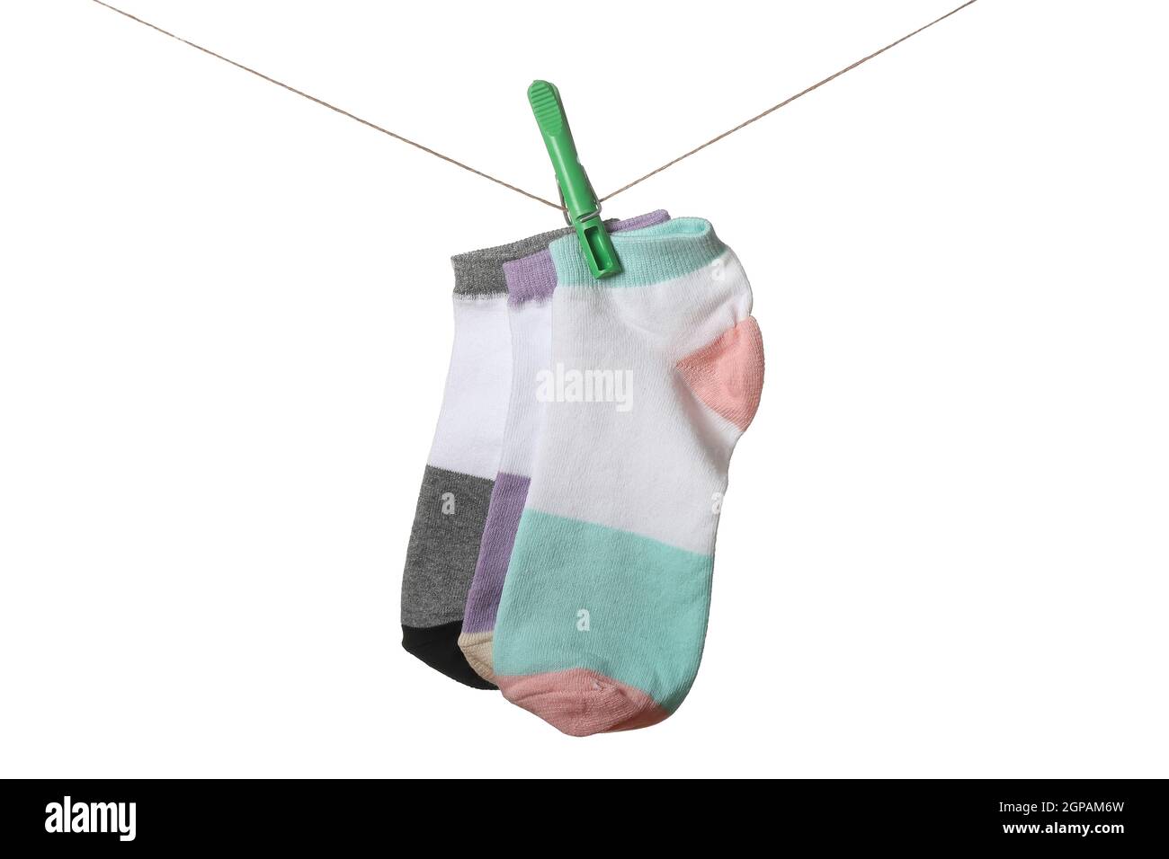 Different socks hanging on clothesline against white background Stock ...