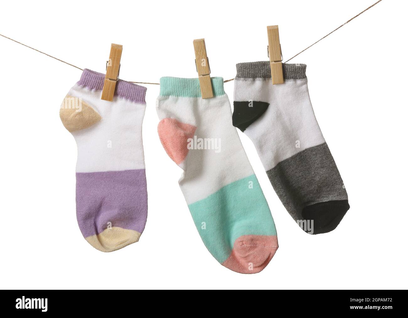 Three socks hanging on rope against white background Stock Photo - Alamy