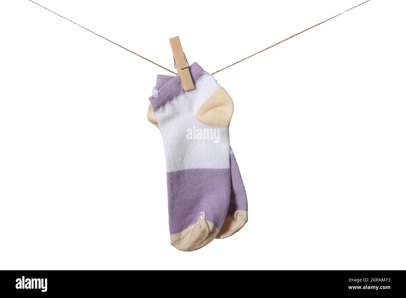 Pair of socks hanging on clothesline against white background Stock ...