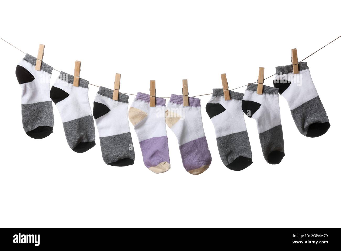 Different socks hanging on rope against white background Stock Photo ...