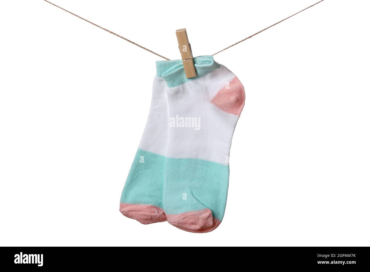 Pair of socks hanging on clothesline against white background Stock ...