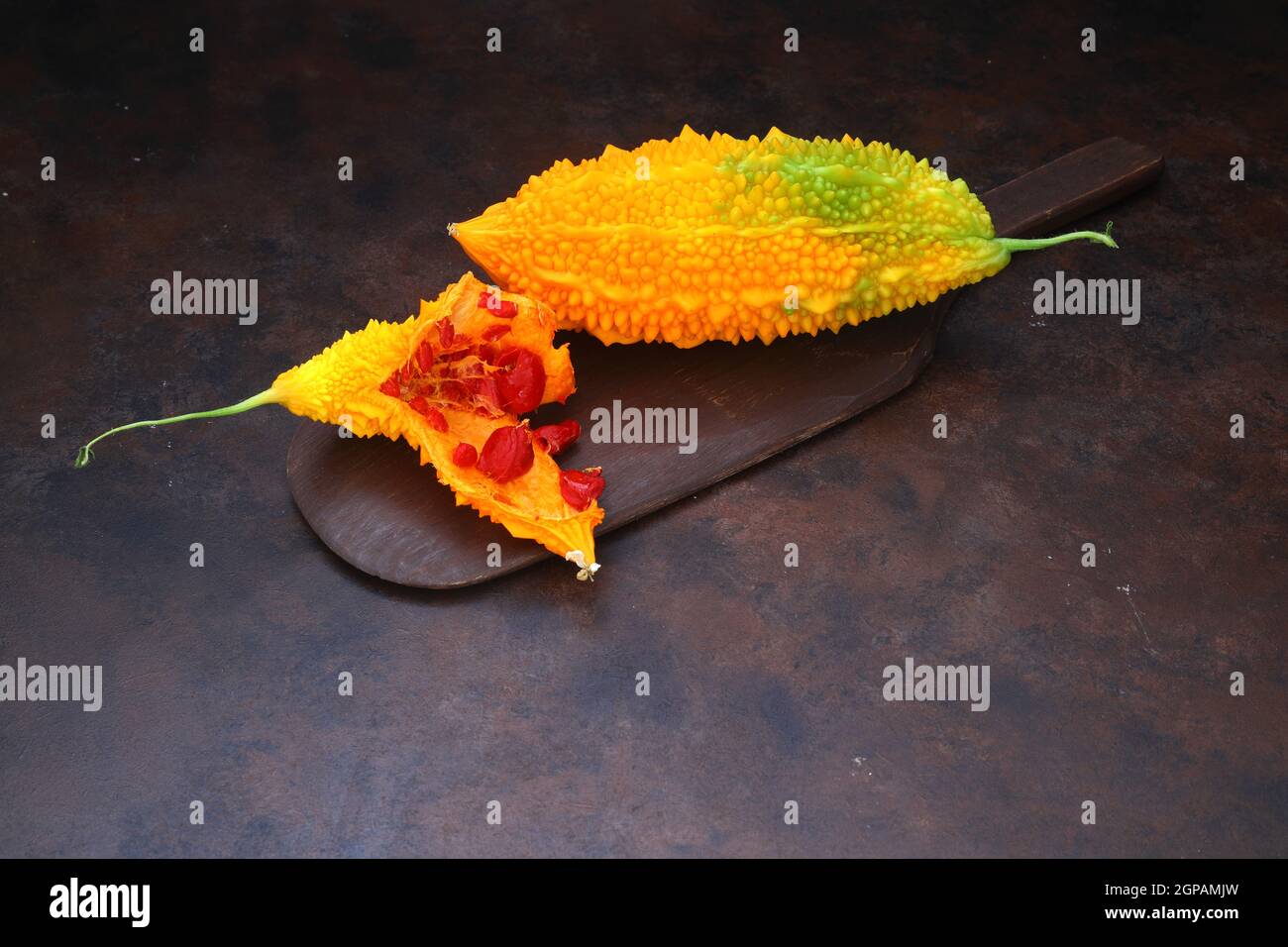 Momordica charantia isolated on a rusty background. Ripe whole fruits ...