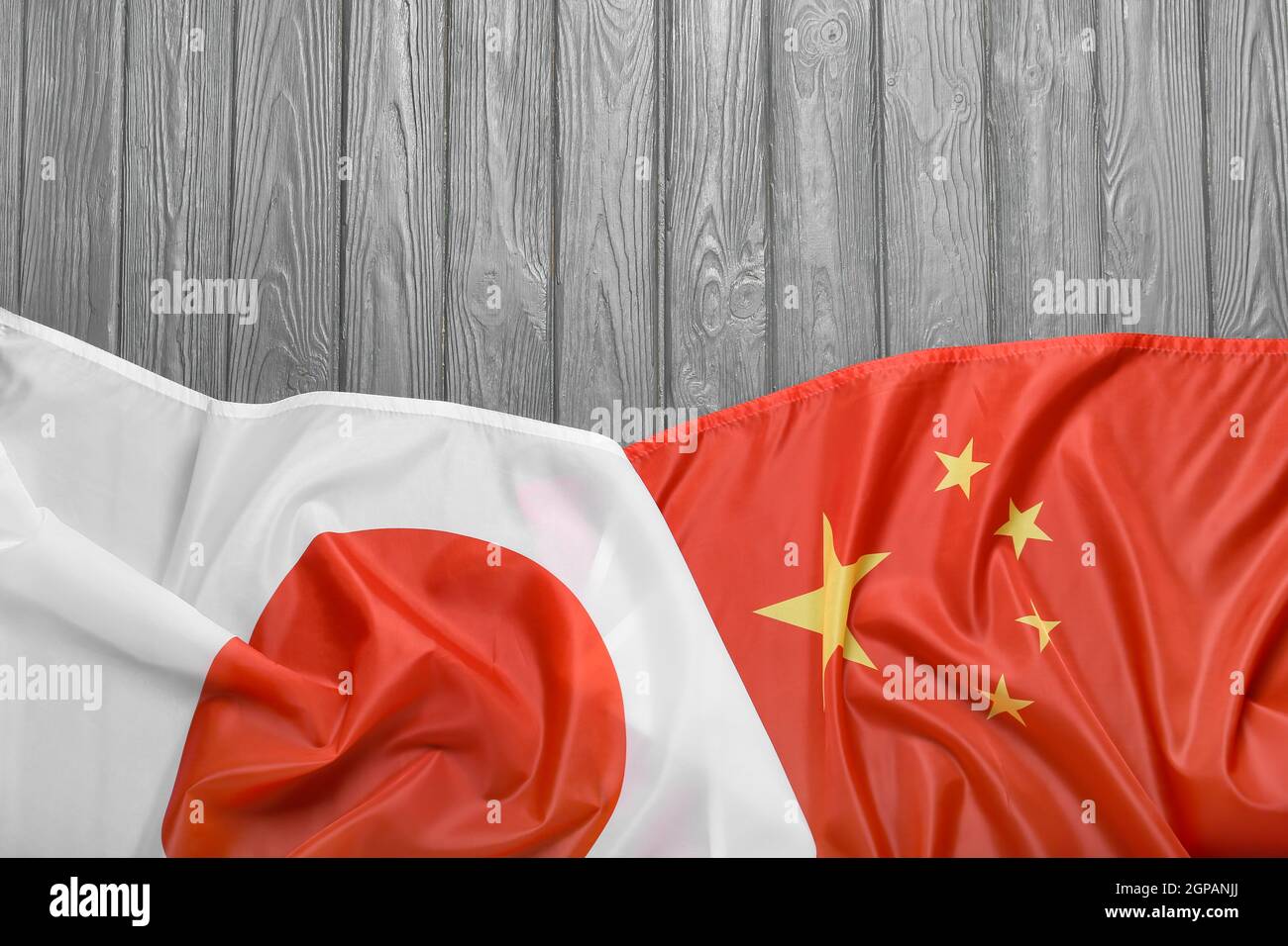 Flags of Japan and China on wooden background Stock Photo - Alamy