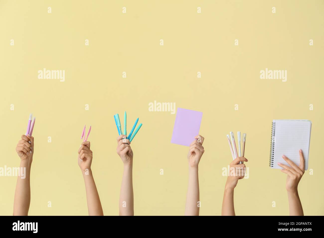 Many different hands with school supplies on color background Stock ...