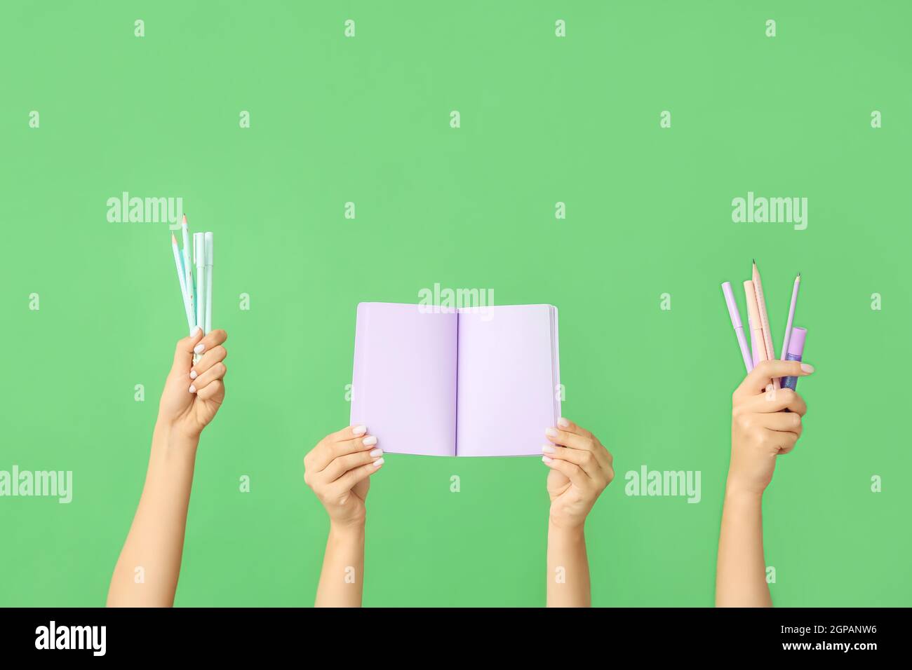 Many different hands with school supplies on green background Stock ...