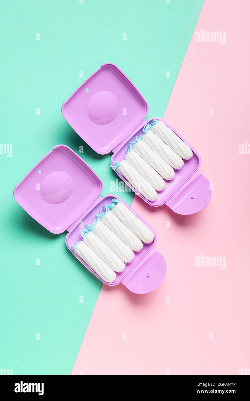 Tampons storage boxes on colorful background, top view Stock Photo - Alamy