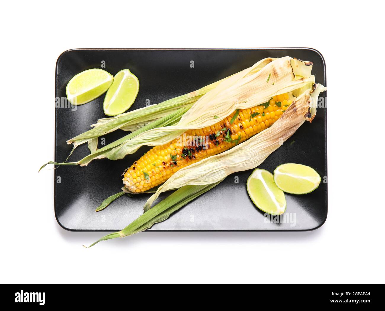 Plate with delicious grilled Mexican street corn on white background ...