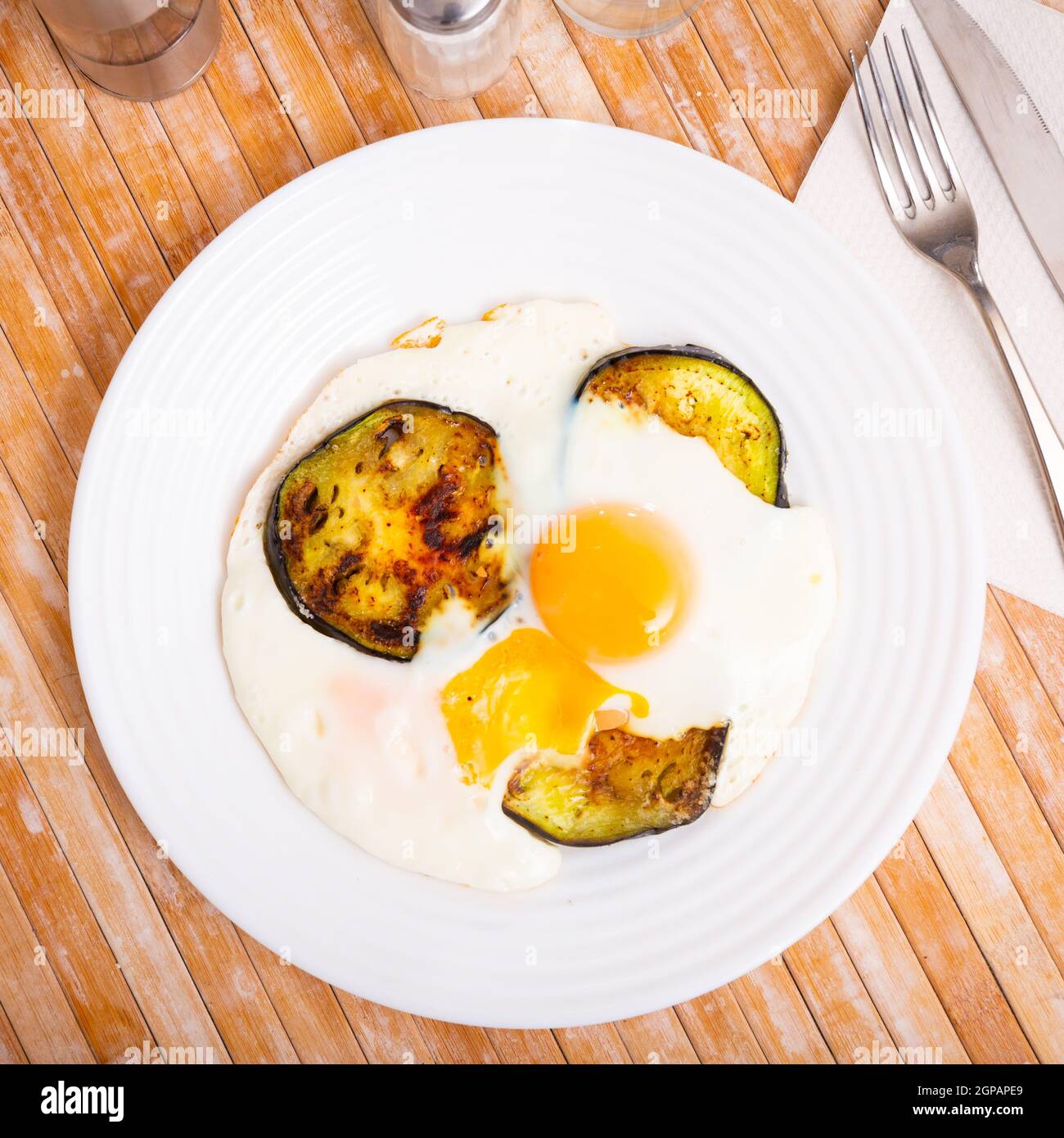 Delicious breakfast - scrambled eggs with fried eggplant closeup Stock ...