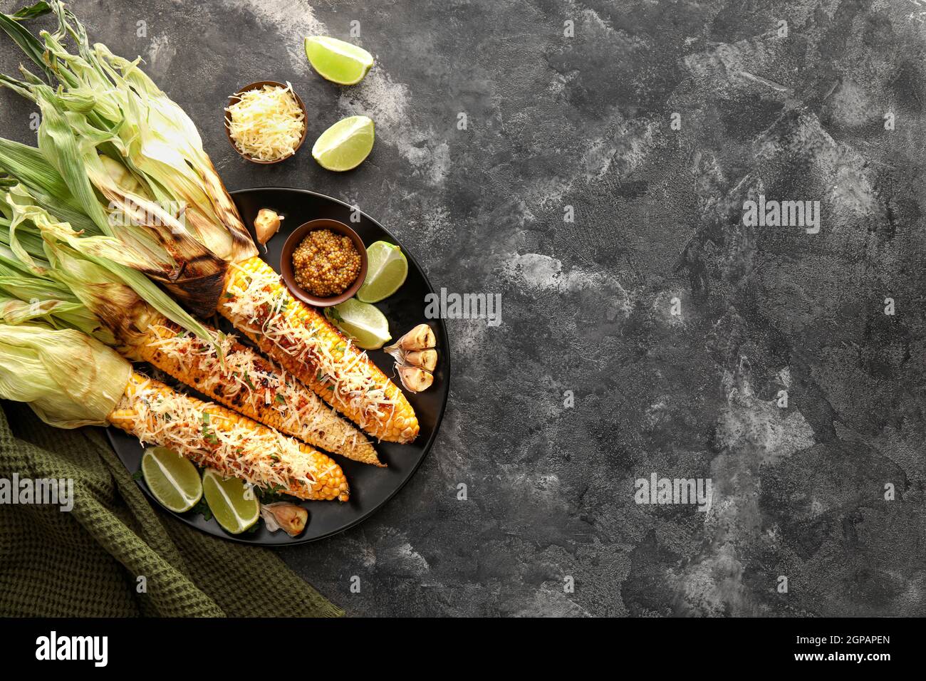 Plate with delicious Elote Mexican Street Corn on black background ...