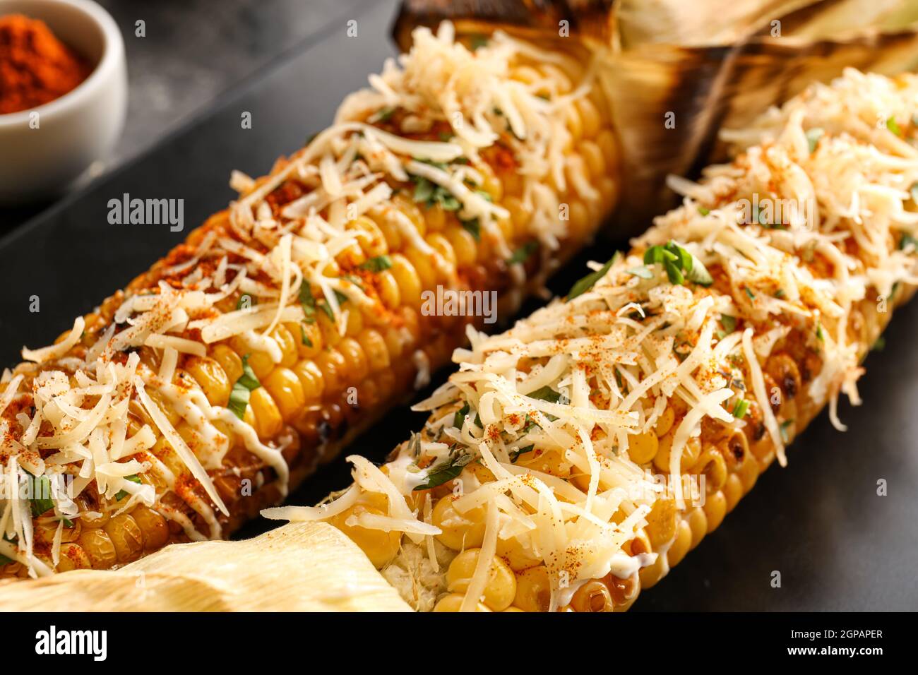 Plate with delicious Elote Mexican Street Corn on black background ...