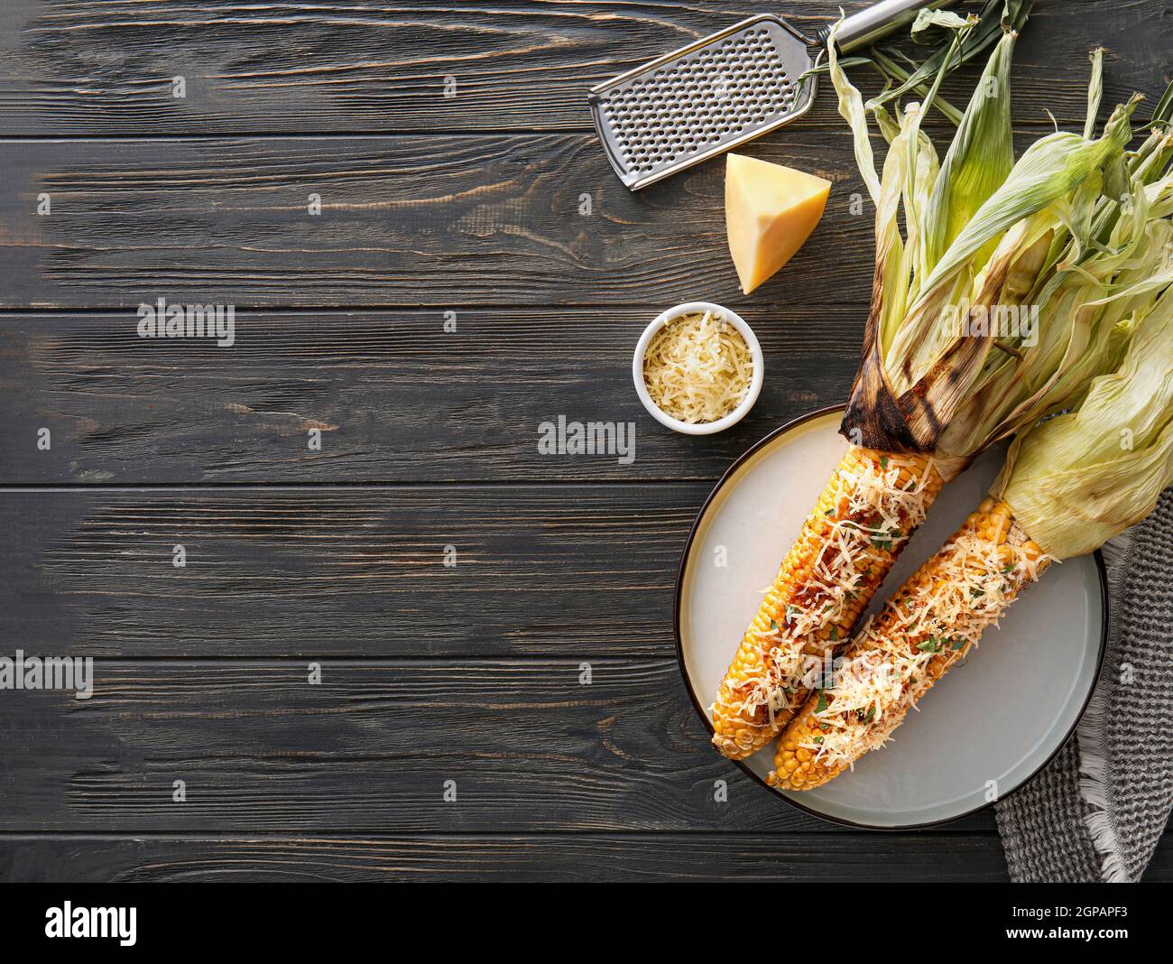 Plate with delicious Elote Mexican Street Corn on black wooden ...