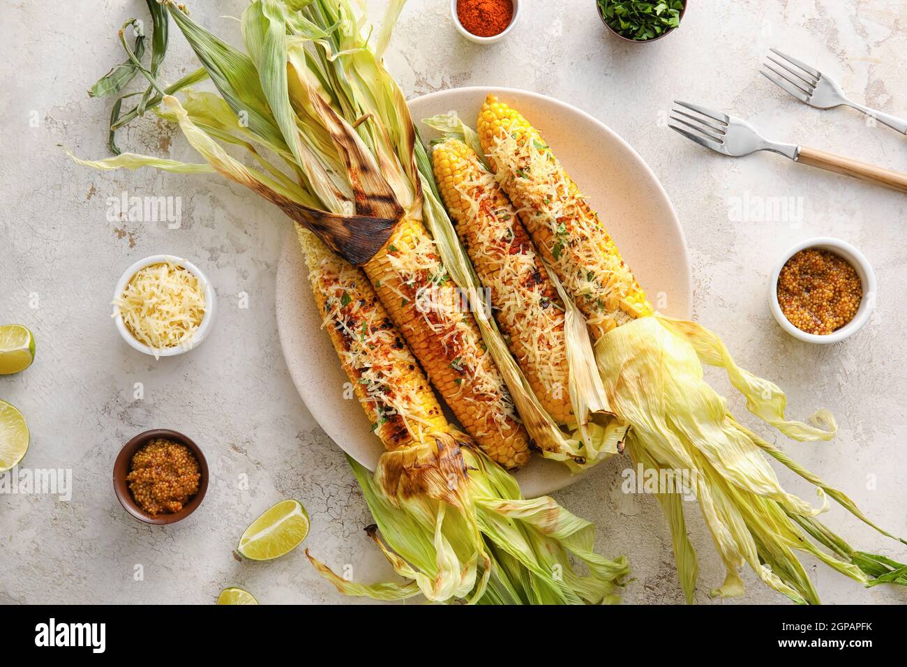 Plate with delicious Elote Mexican Street Corn and spices on light ...