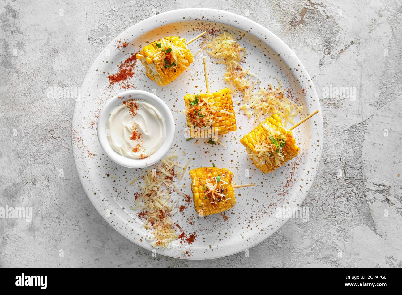 Plate with pieces of delicious Elote Mexican Street Corn on light ...