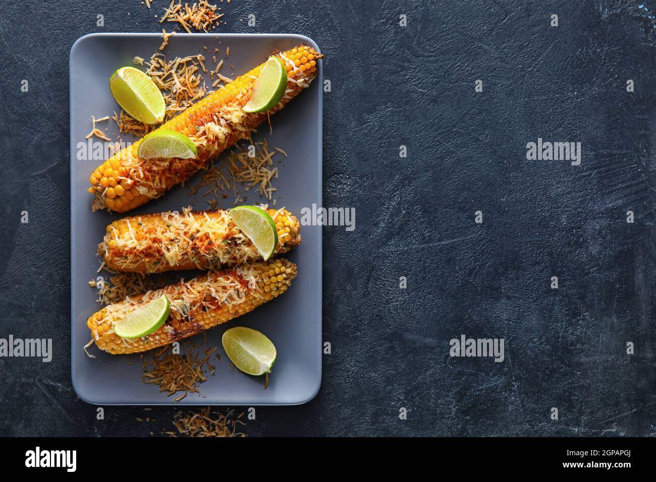 Plate with delicious Elote Mexican Street Corn on black background ...