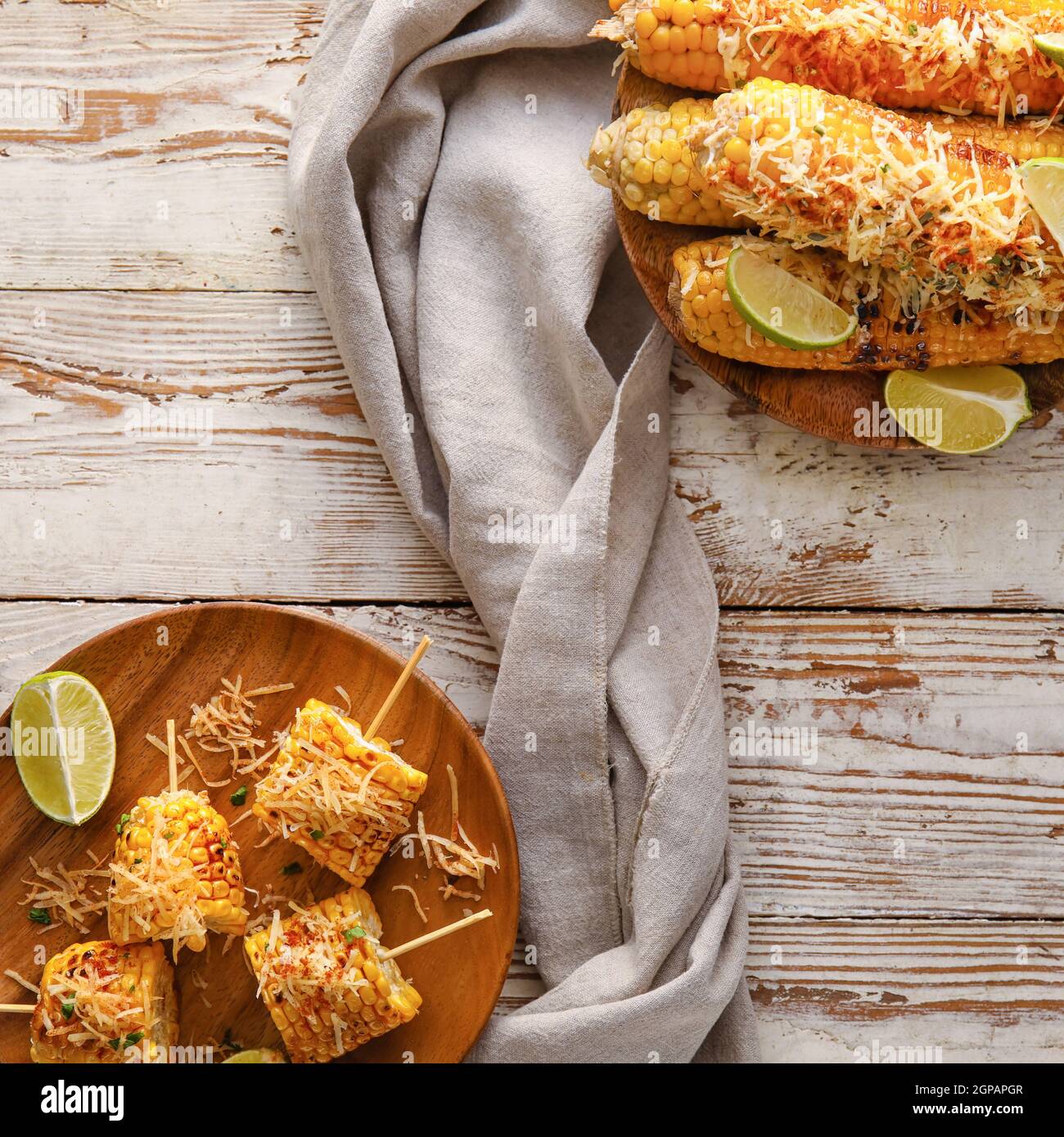Plates with pieces of delicious Elote Mexican Street Corn on white ...