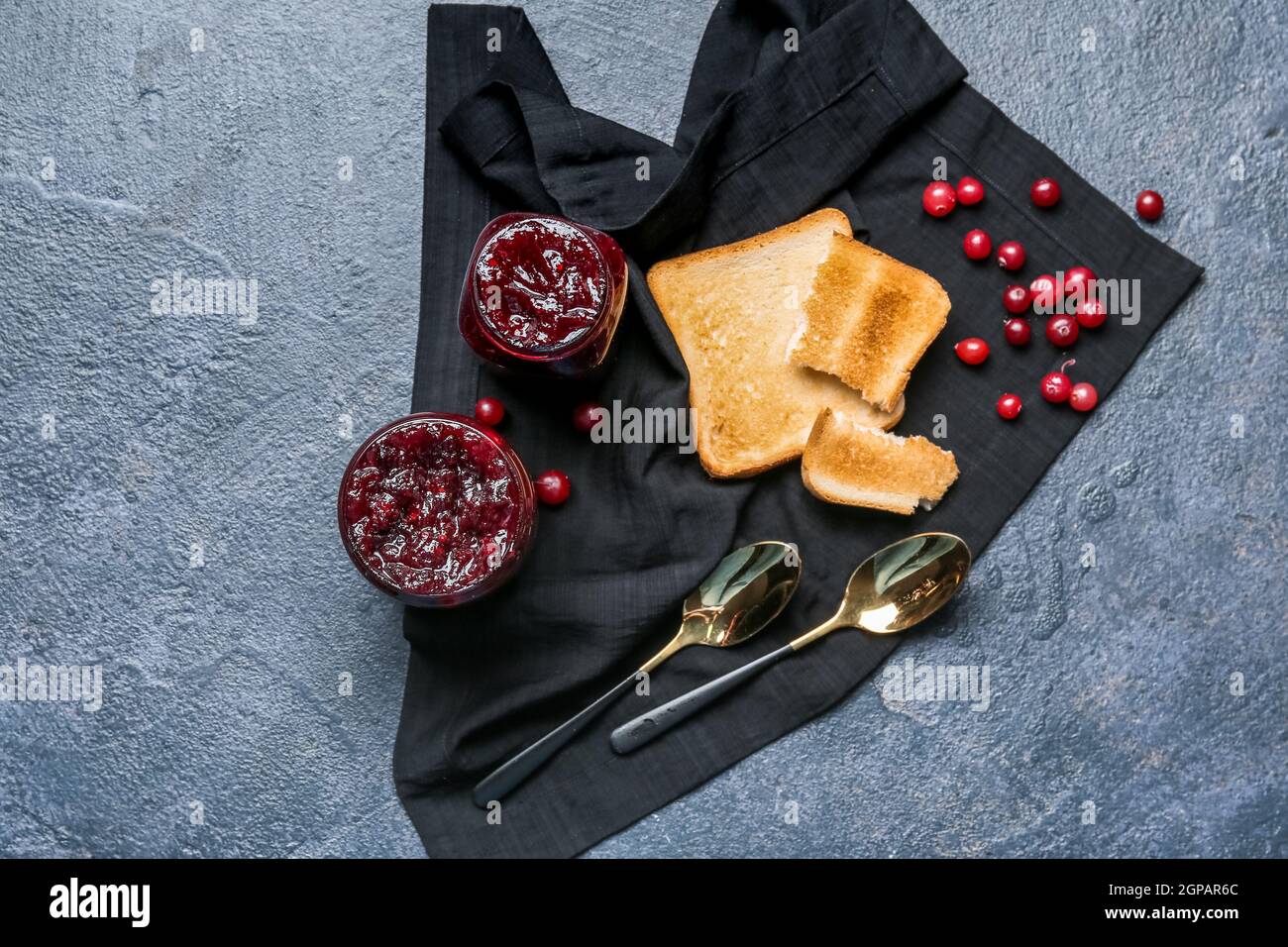 Composition with toasts, berries and cranberry jam on dark background ...