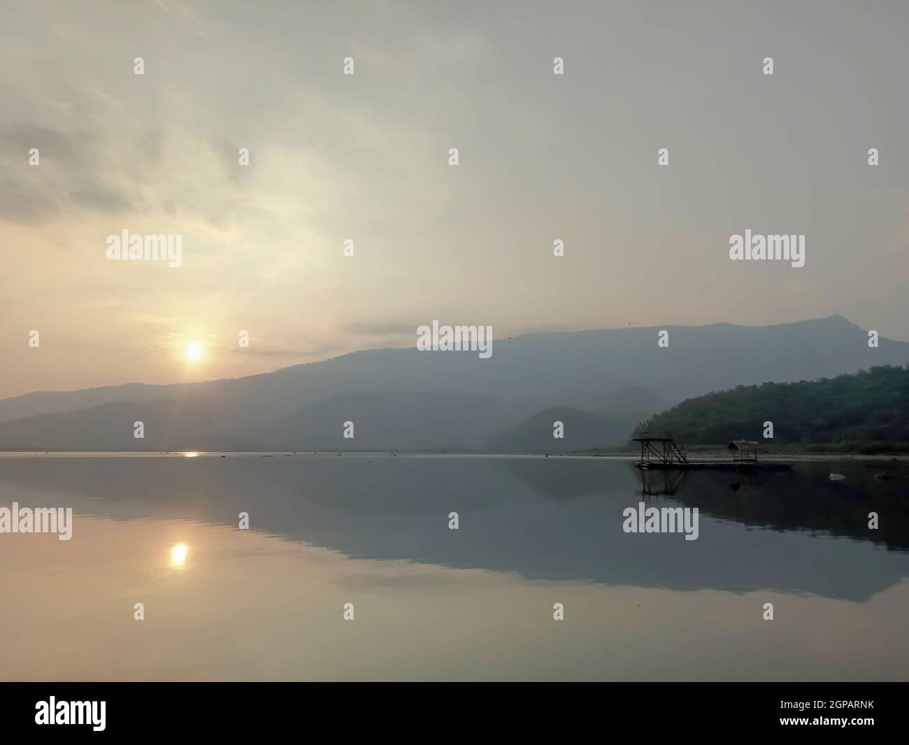 Bamboo raft floating in lake with mountain background. Lake reflection ...