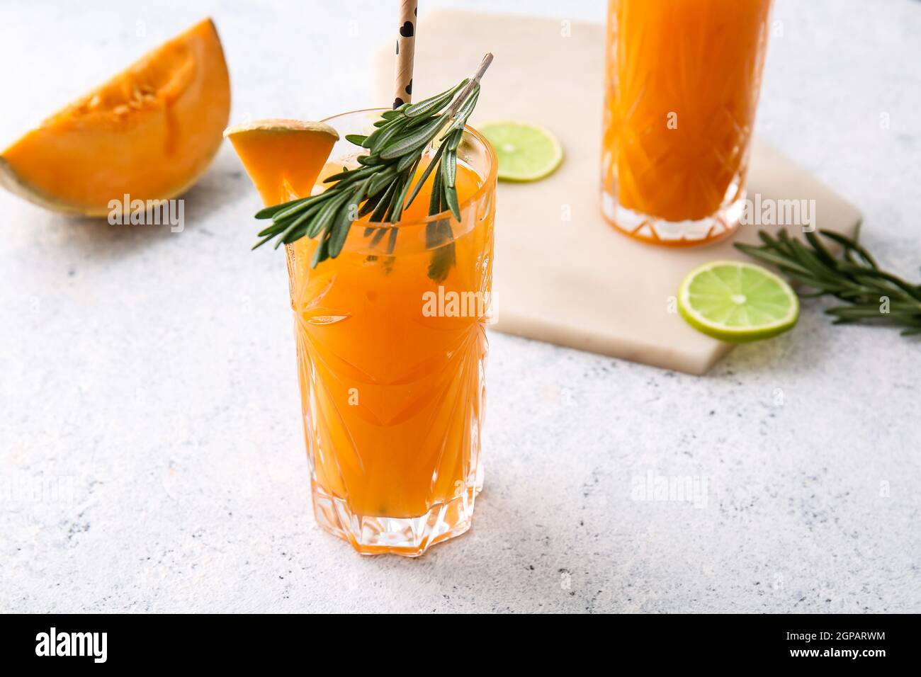 Glass of cold melon cocktail on light background Stock Photo - Alamy