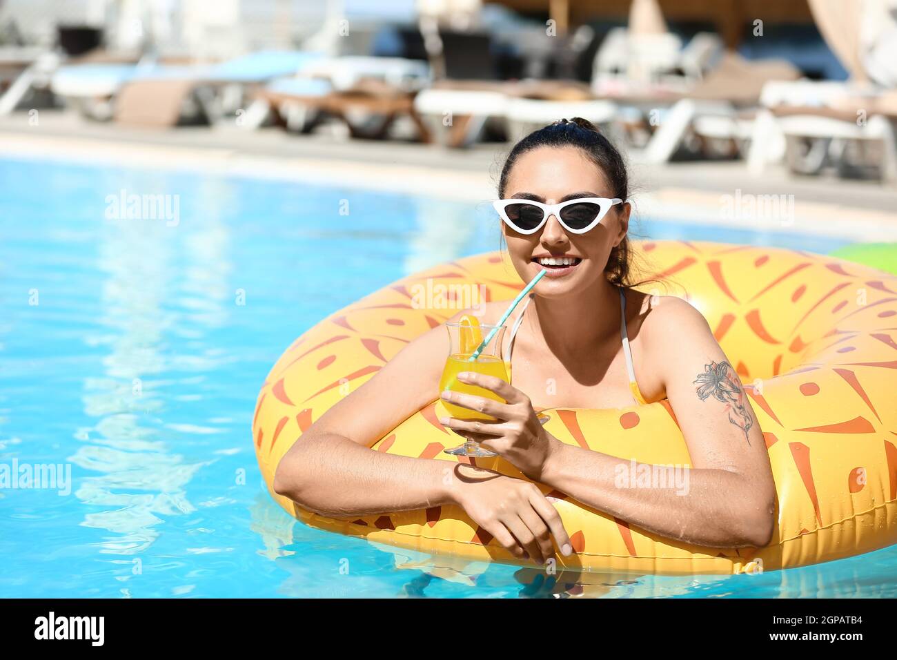 Beautiful woman drinking pineapple cocktail hi-res stock photography ...