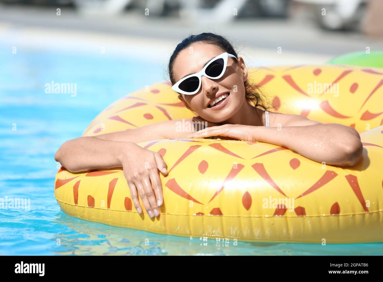 Young woman with inflatable ring in swimming pool Stock Photo - Alamy