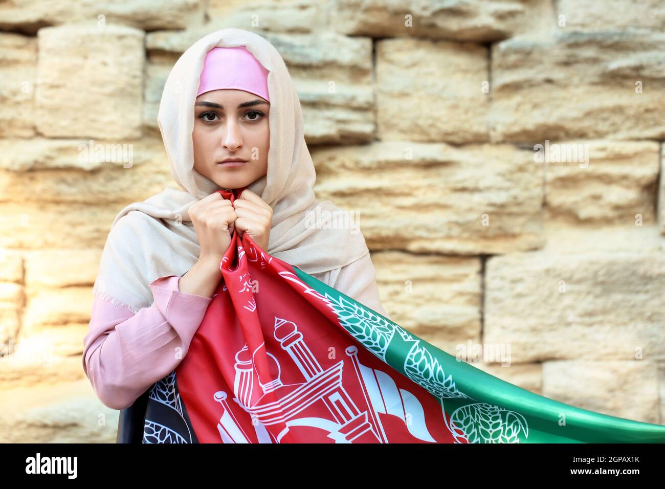Muslim woman with flag of Afghanistan on city street Stock Photo - Alamy