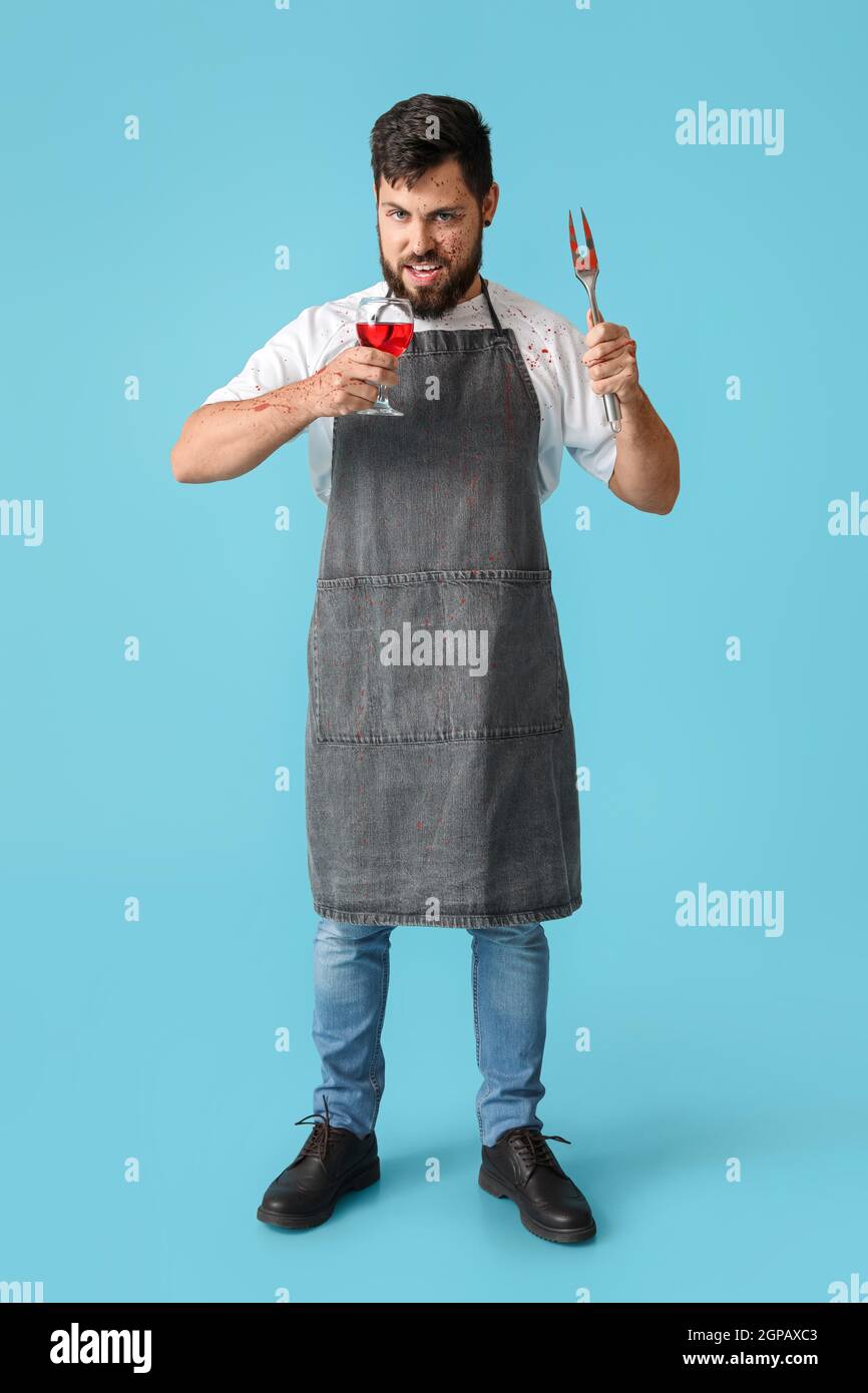 Man dressed as butcher for Halloween on color background Stock Photo ...