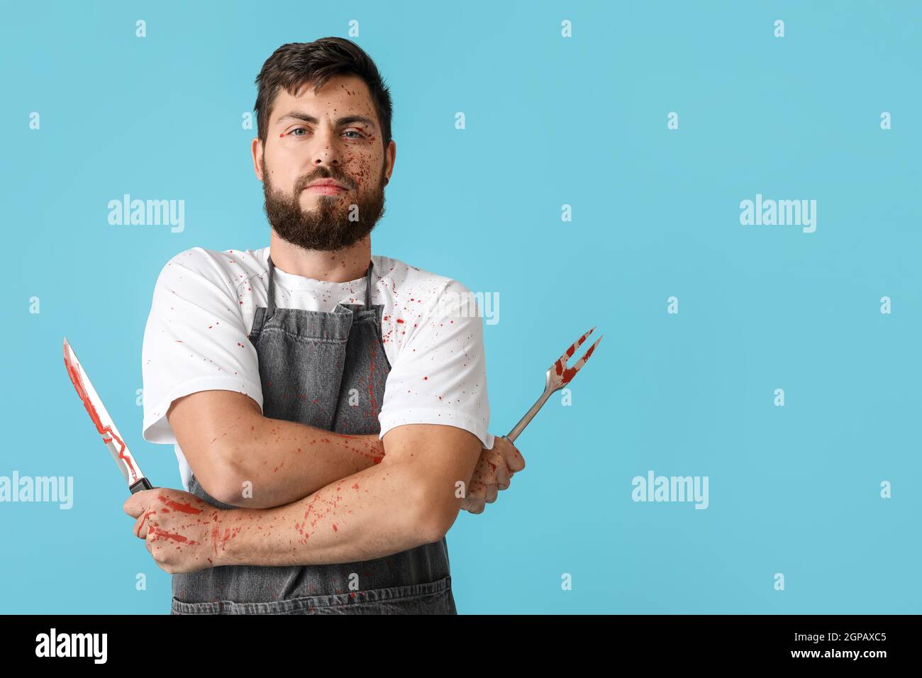 Man dressed as butcher for Halloween on color background Stock Photo ...