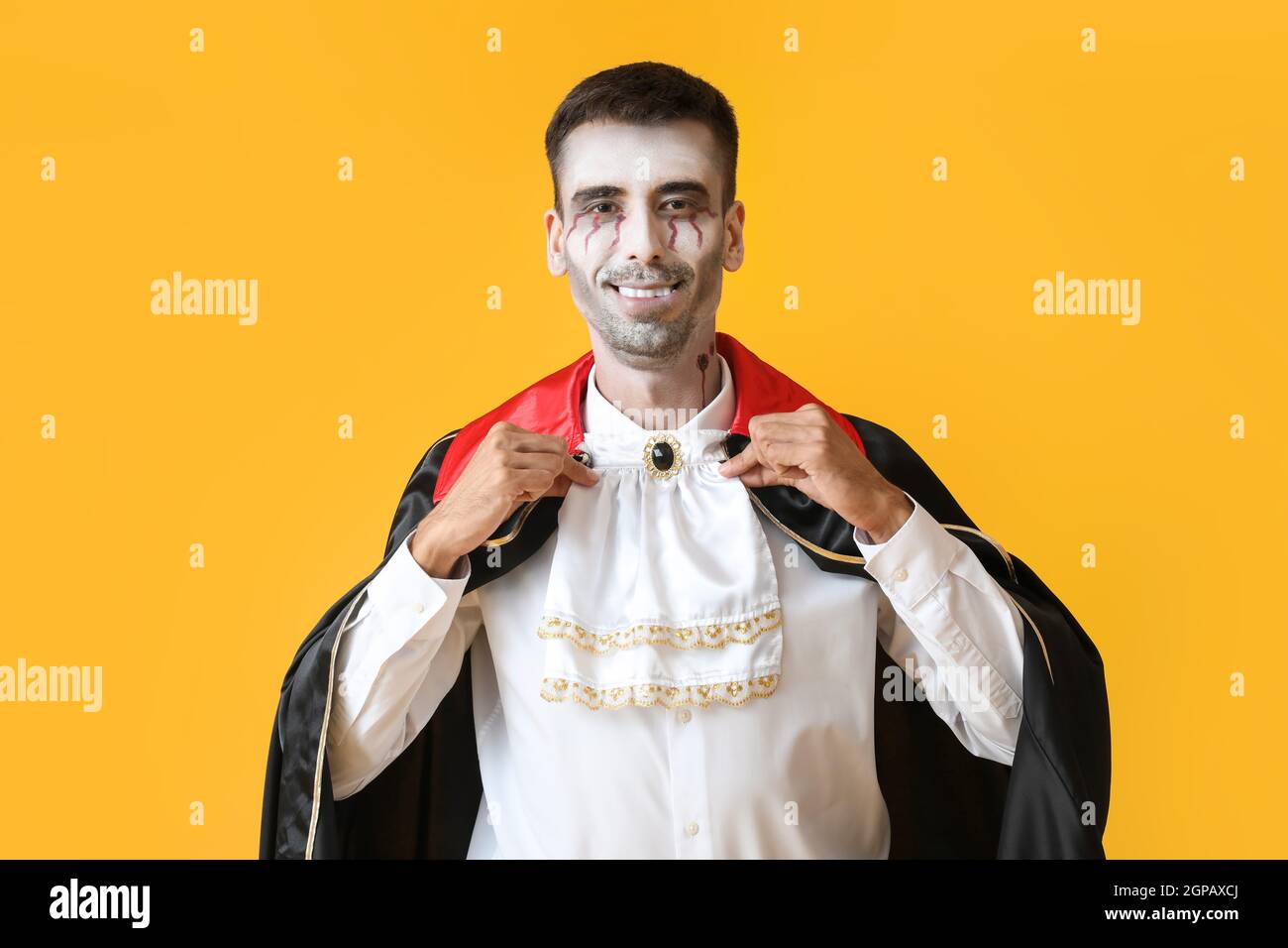Man dressed as vampire for Halloween on color background Stock Photo ...