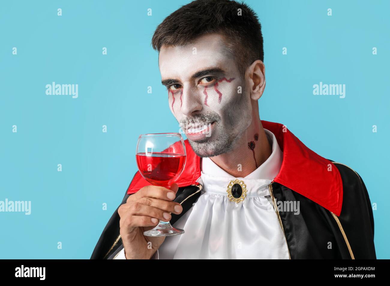 Man dressed as vampire for Halloween on color background Stock Photo ...