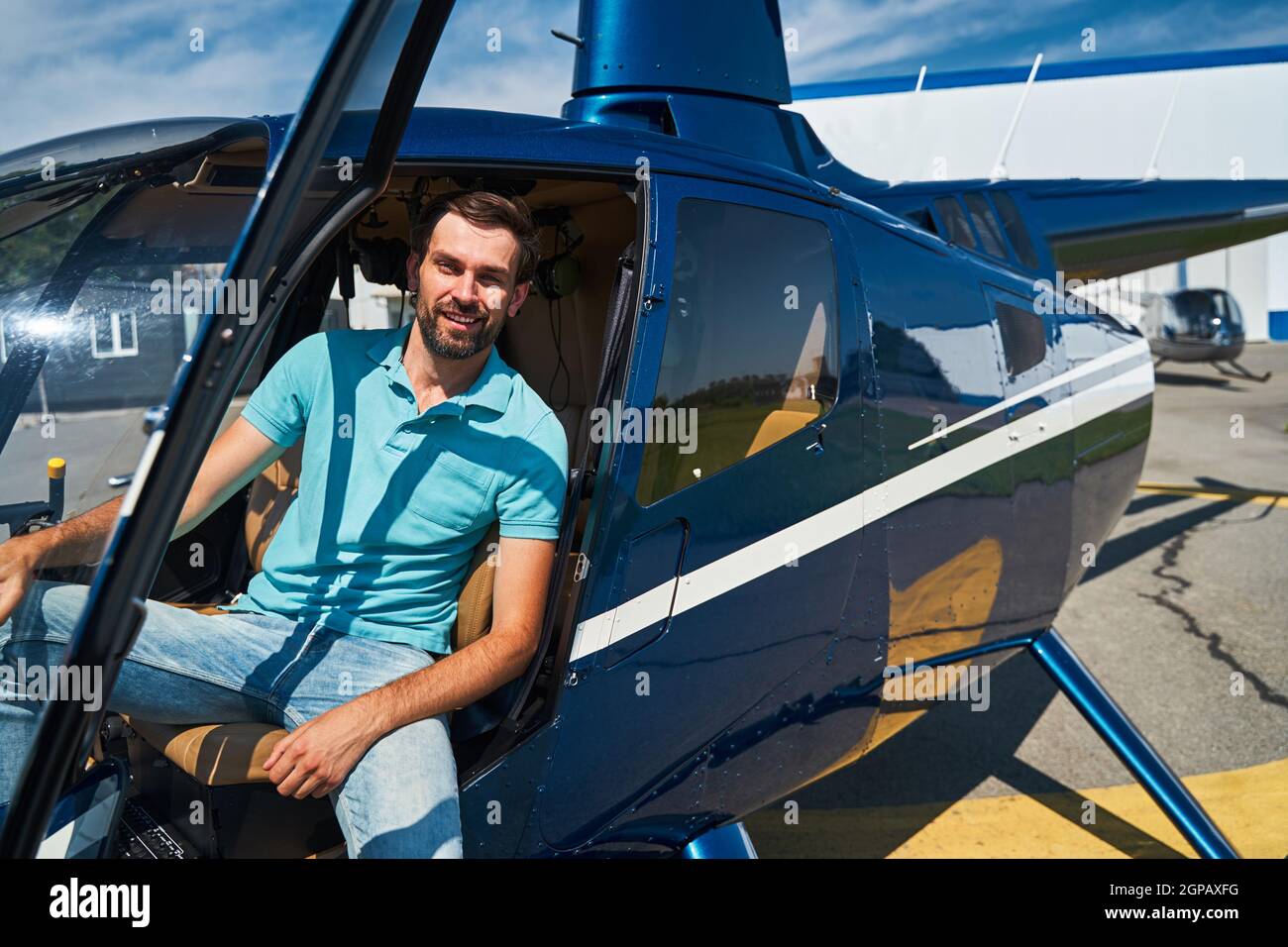Happy male pilot posing for camera before helicopter flight Stock Photo ...