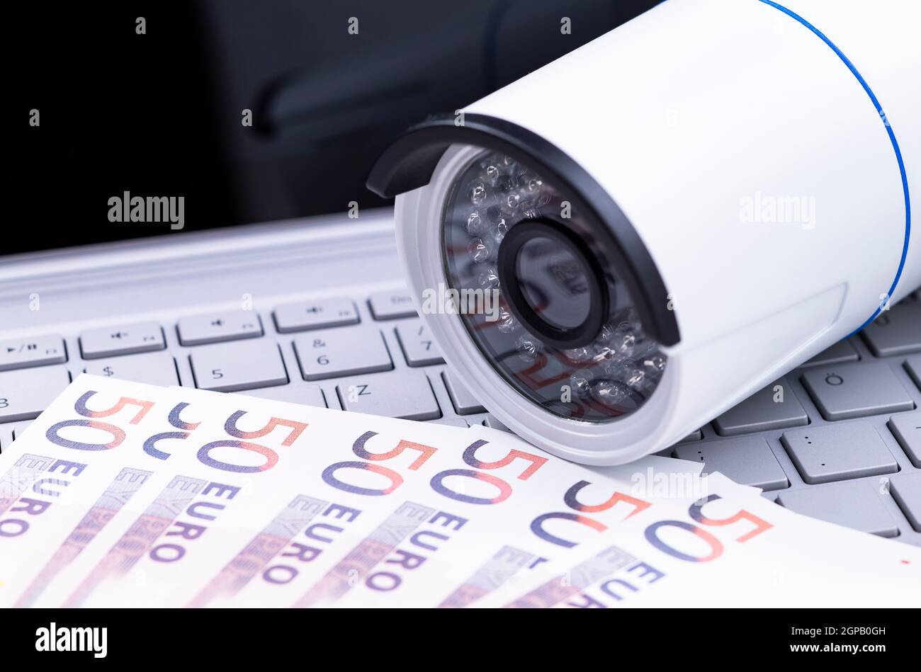 The photo shows a security camera with banknotes on a computer Stock ...