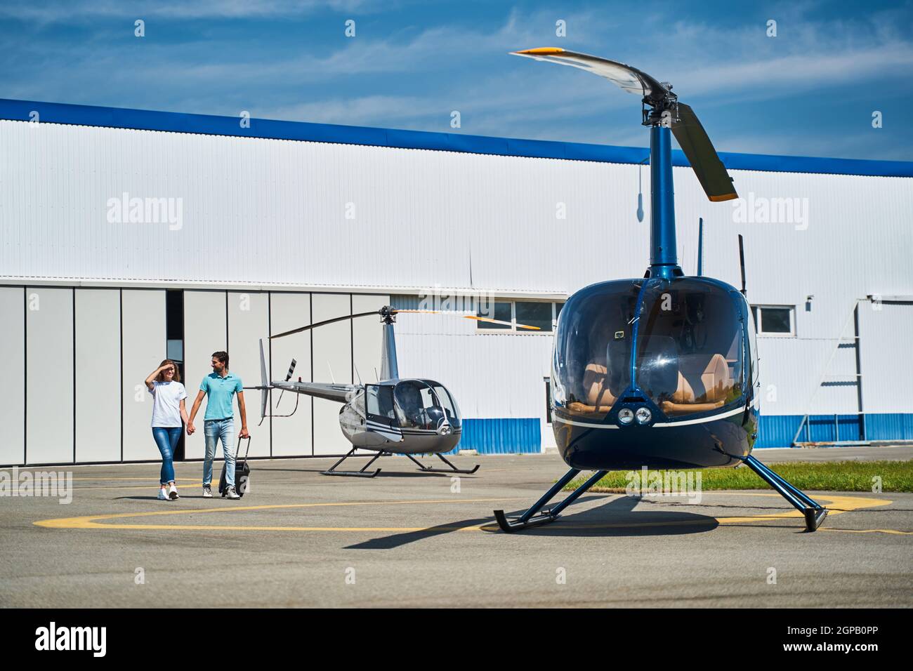 Happy Caucasian tourist couple moving towards empty chopper Stock Photo ...