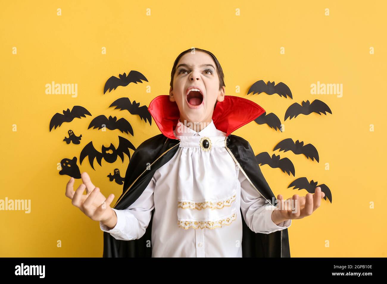 Cute little boy dressed as vampire for Halloween on color background ...