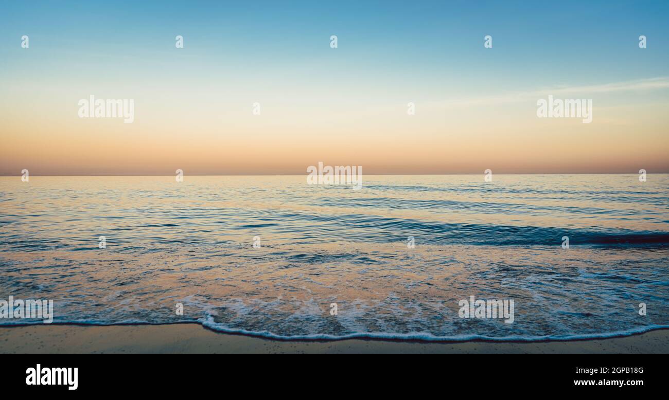 Calm sea at dusk with afterglow Stock Photo - Alamy