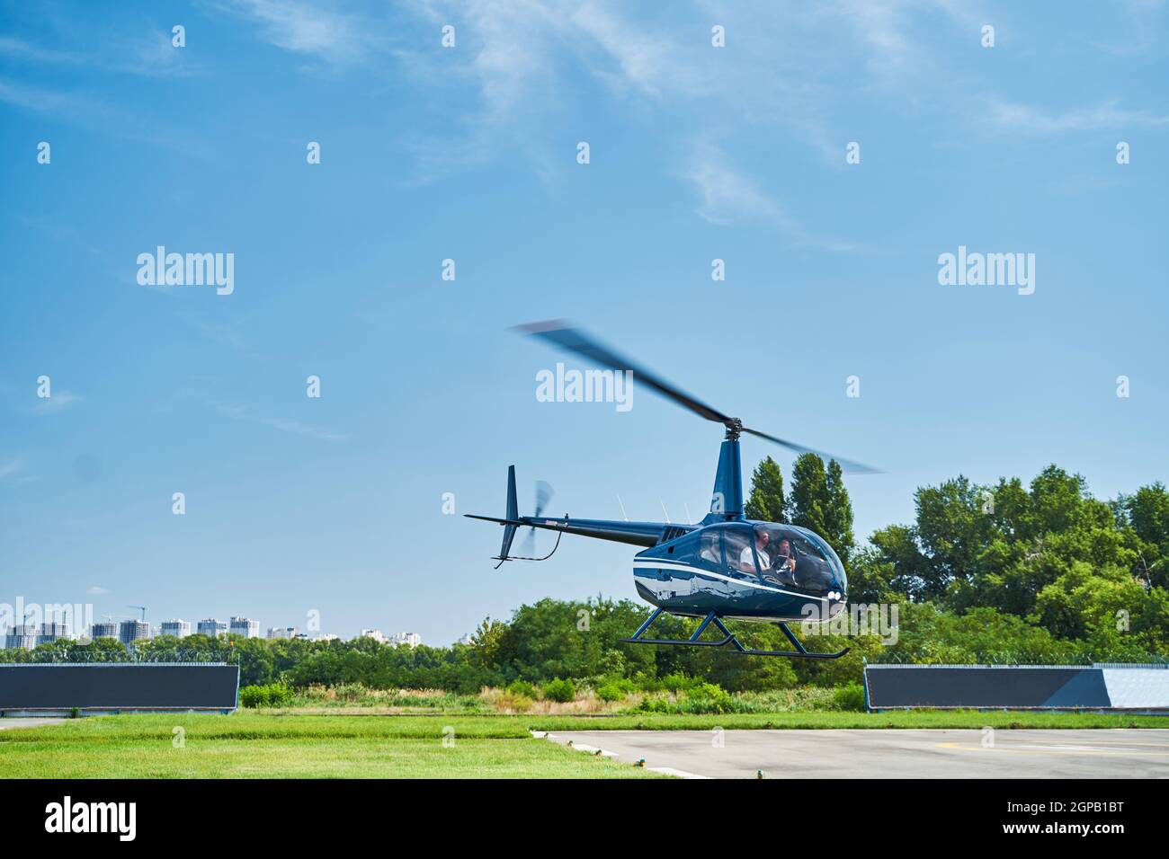 Manned helicopter taking off from landing pad at heliport Stock Photo ...