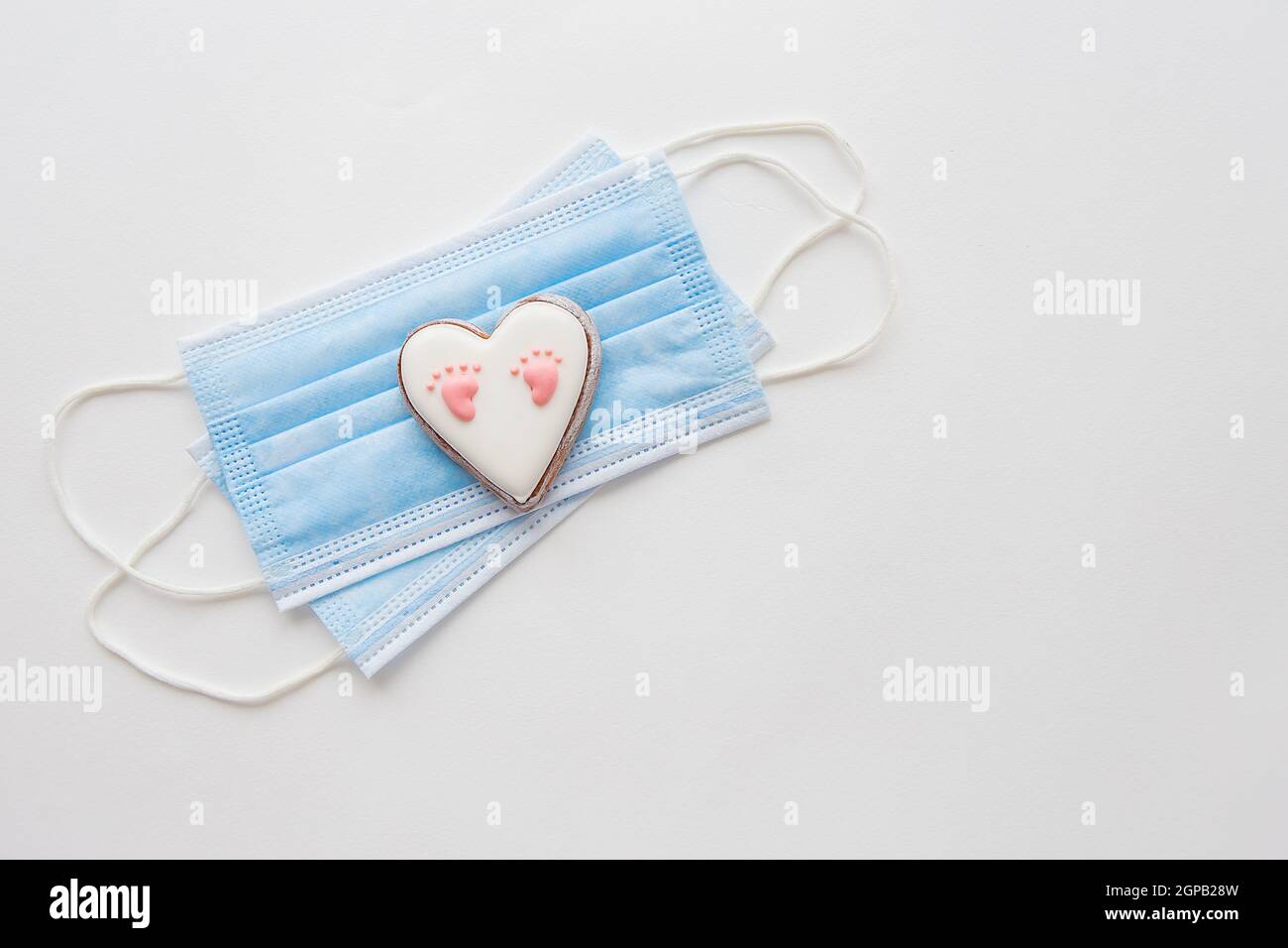 Disposable medical mask and two hearts. Heart with baby footprint ...
