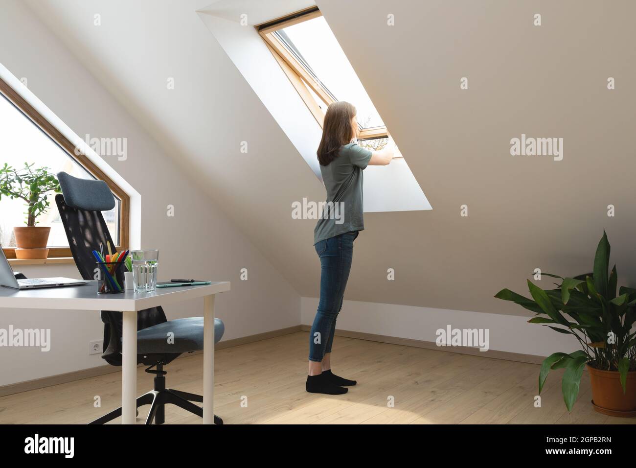 Women opening a window at home office and letting fresh air in. Healthy ...
