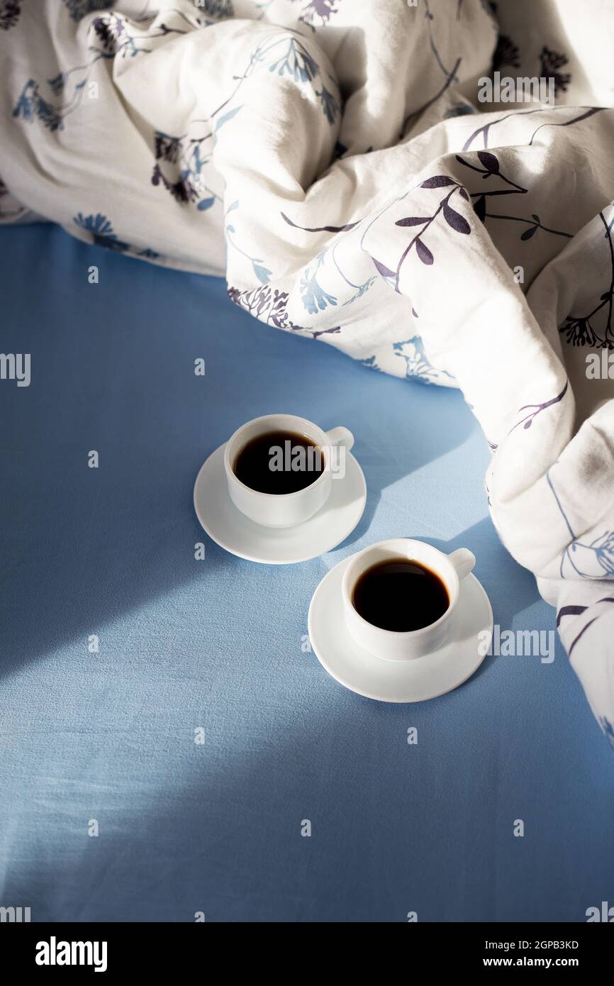 two cups of coffee in bed, sunlight Stock Photo - Alamy