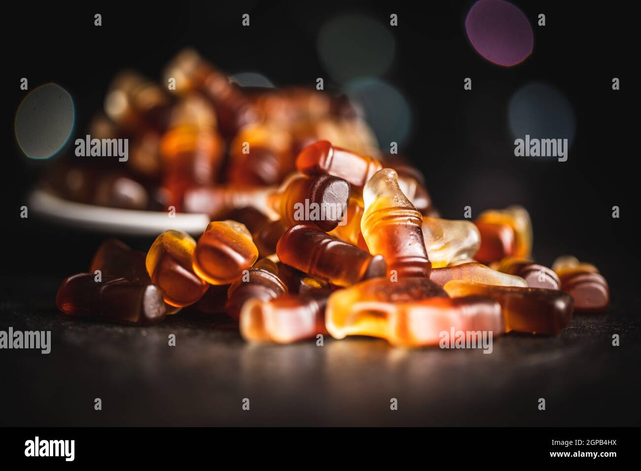 Jelly candies with cola flavor on black table Stock Photo - Alamy