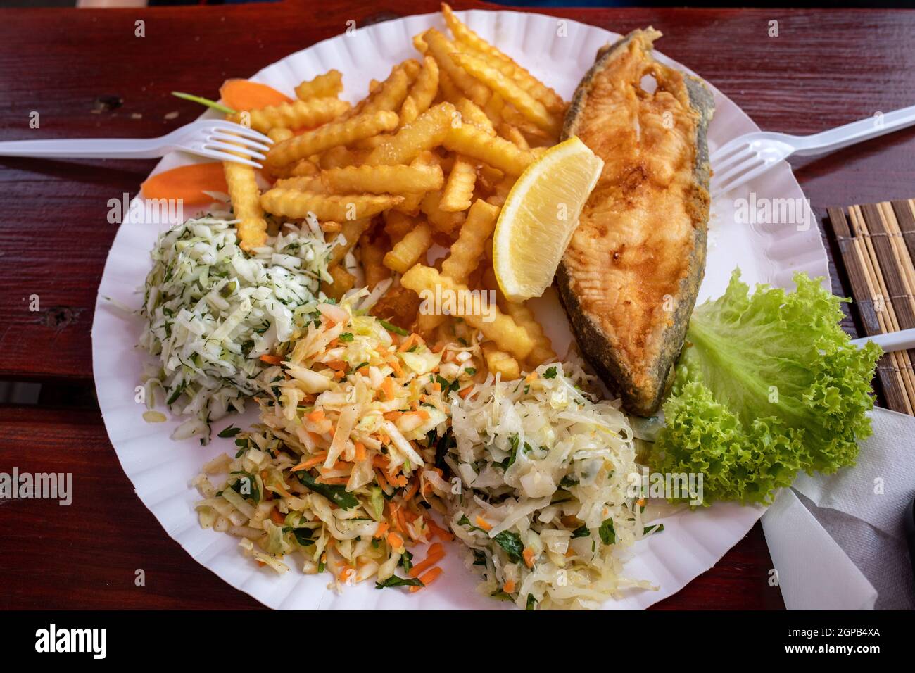 Fried fish with fries and vegetable salad Stock Photo - Alamy