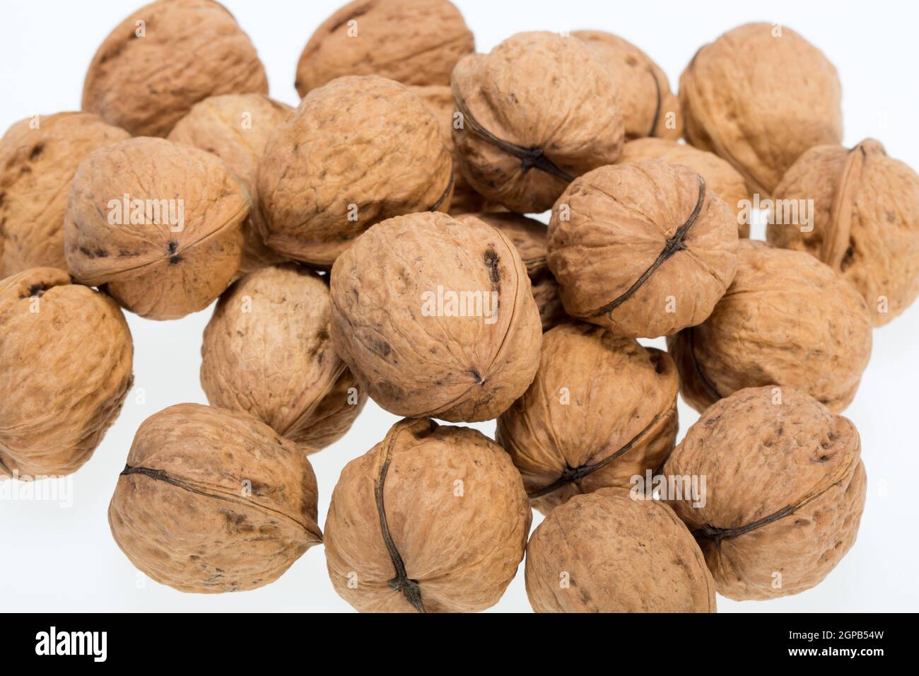 walnuts heap isolated on white background Stock Photo - Alamy