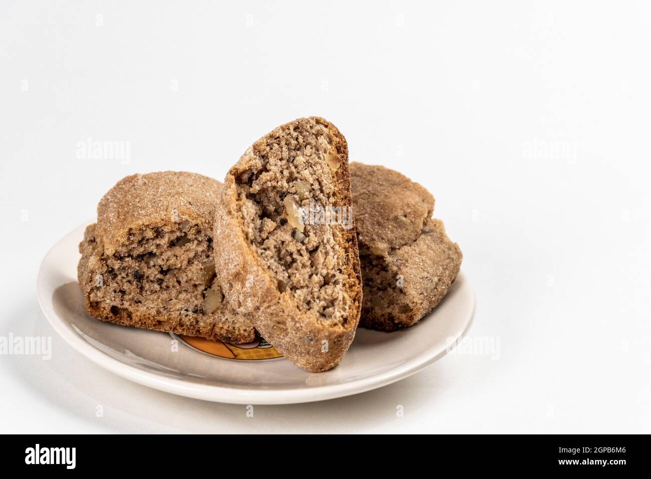 Dry biscuit cookies from the package lies on a white plate against ...
