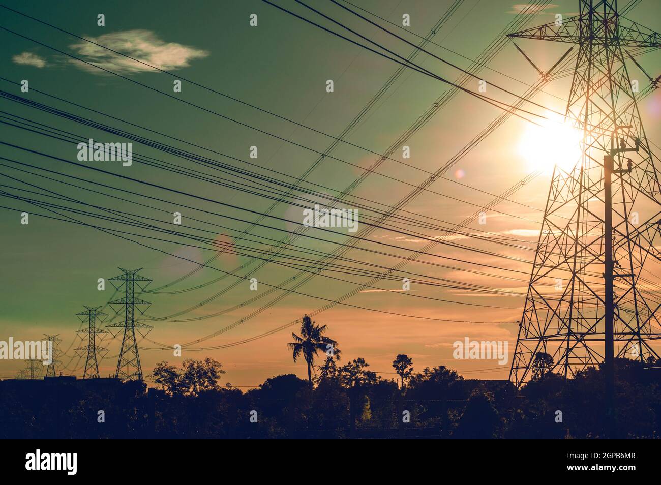 Electric power line plant station tower pole in the field on sunset ...