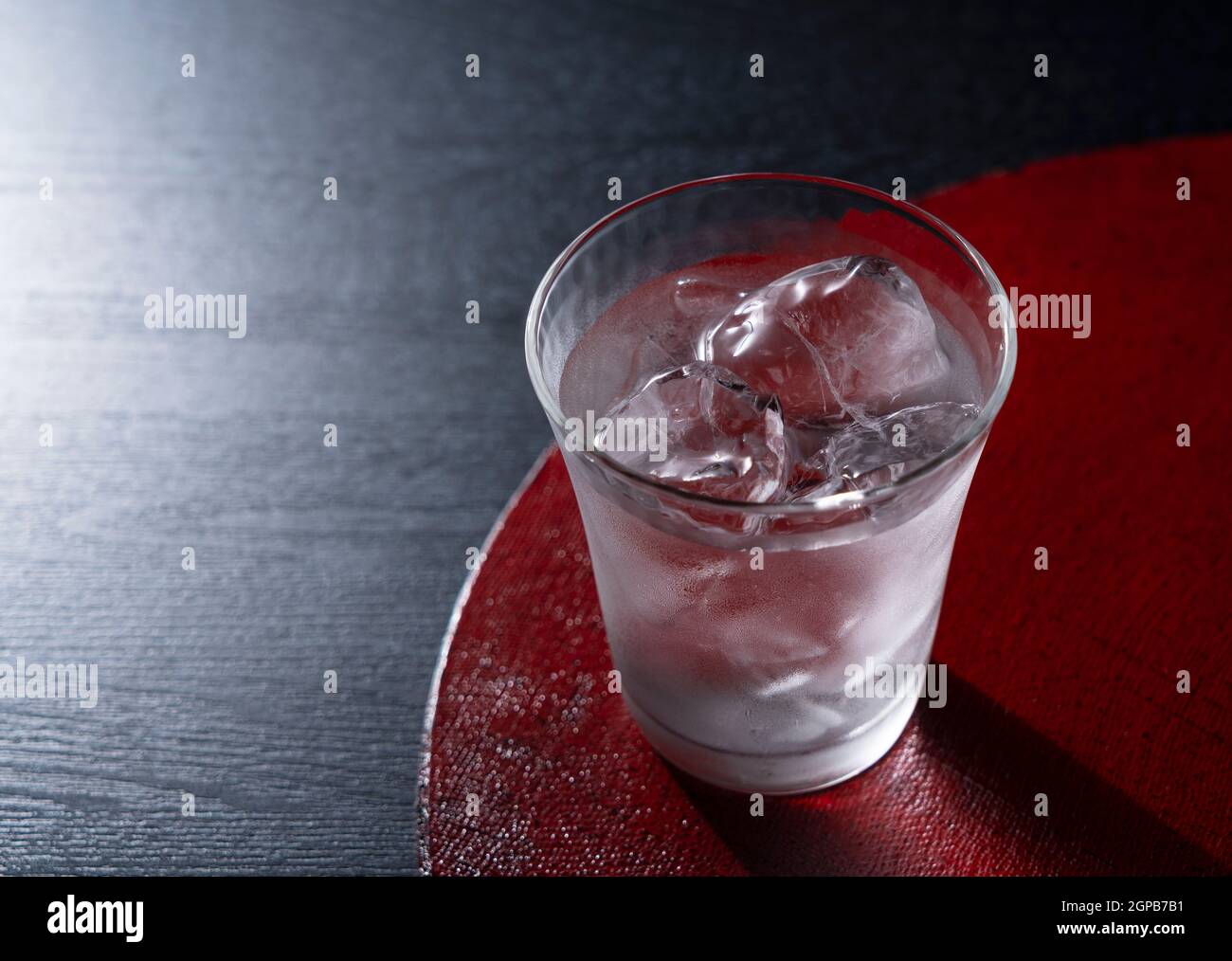 Shochu placed on a red tray against a black background. Image of ...