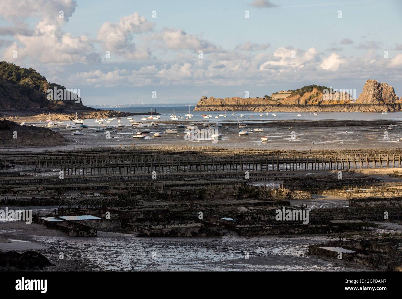 Boats on dry land at the beach at low tide in Cancale famous oysters ...